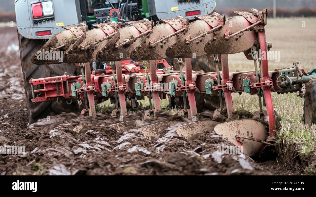 Landscape of tractor and plough, ploughing a field in Angus, Scotland ...