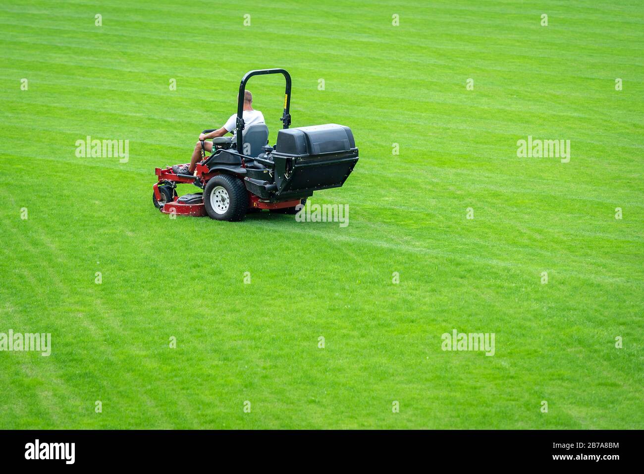 Mowing grass at the football stadium Stock Photo - Alamy