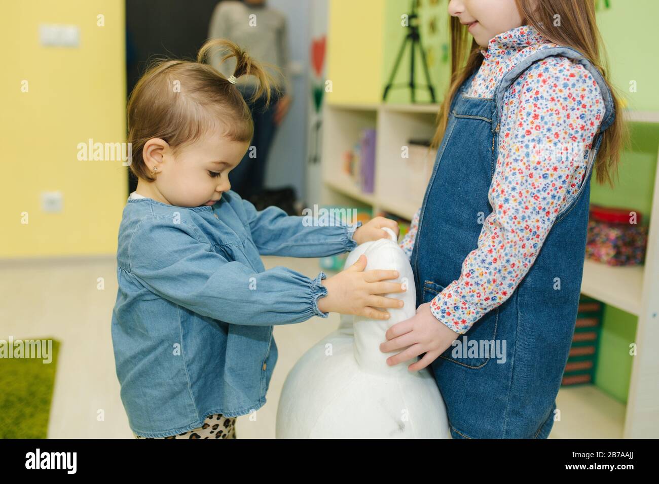 Little girl help little baby in nursery. Cute children play Stock Photo ...