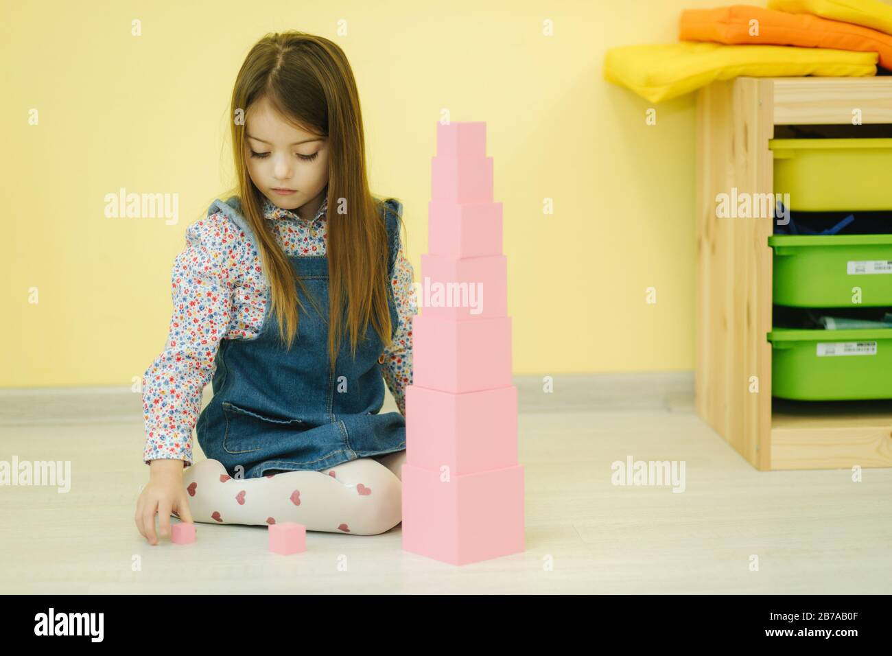 Clever little girl built tower in preschool academy for children Stock ...
