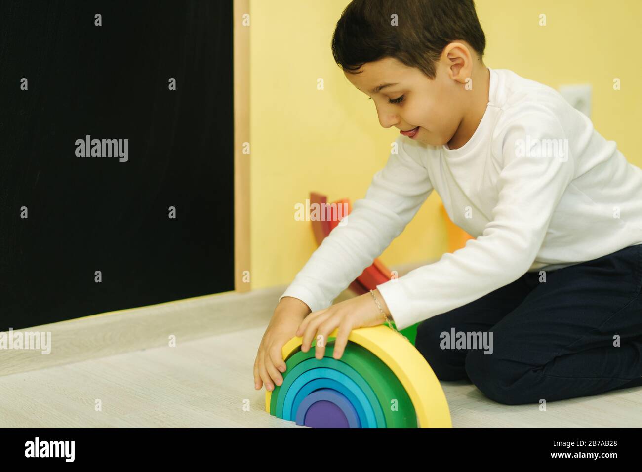 Boys play in different intelectual games in preschool classroom Stock ...