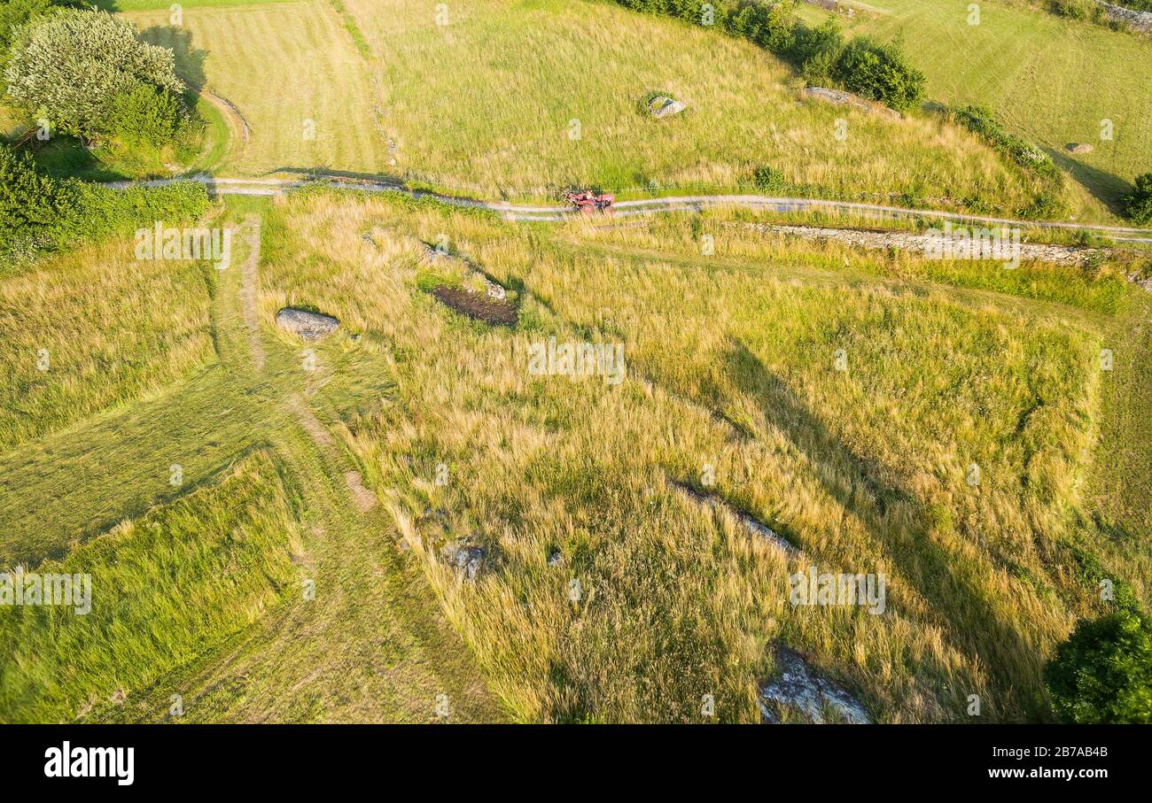 tractor dedicated to hay processing Stock Photo - Alamy