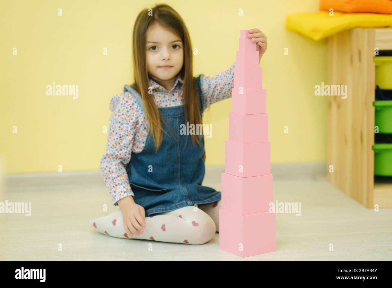 Clever little girl built tower in preschool academy for children Stock ...