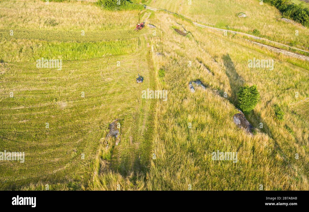tractor dedicated to hay processing Stock Photo - Alamy