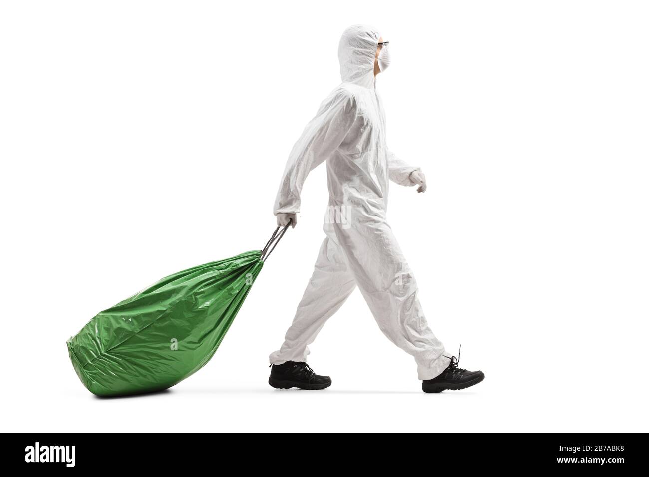 Full length profile shot of a man in a protective suit walking and ...