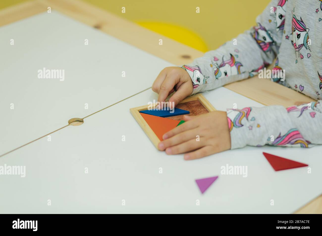 Close up of children play with different figures on the table Stock ...