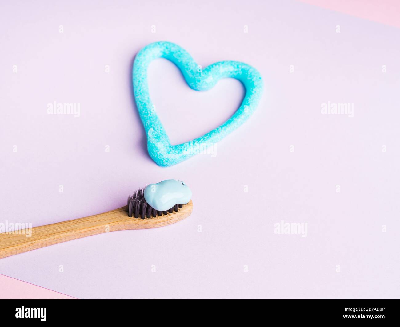 Toothbrush and toothpaste heart on pastel pink Stock Photo - Alamy