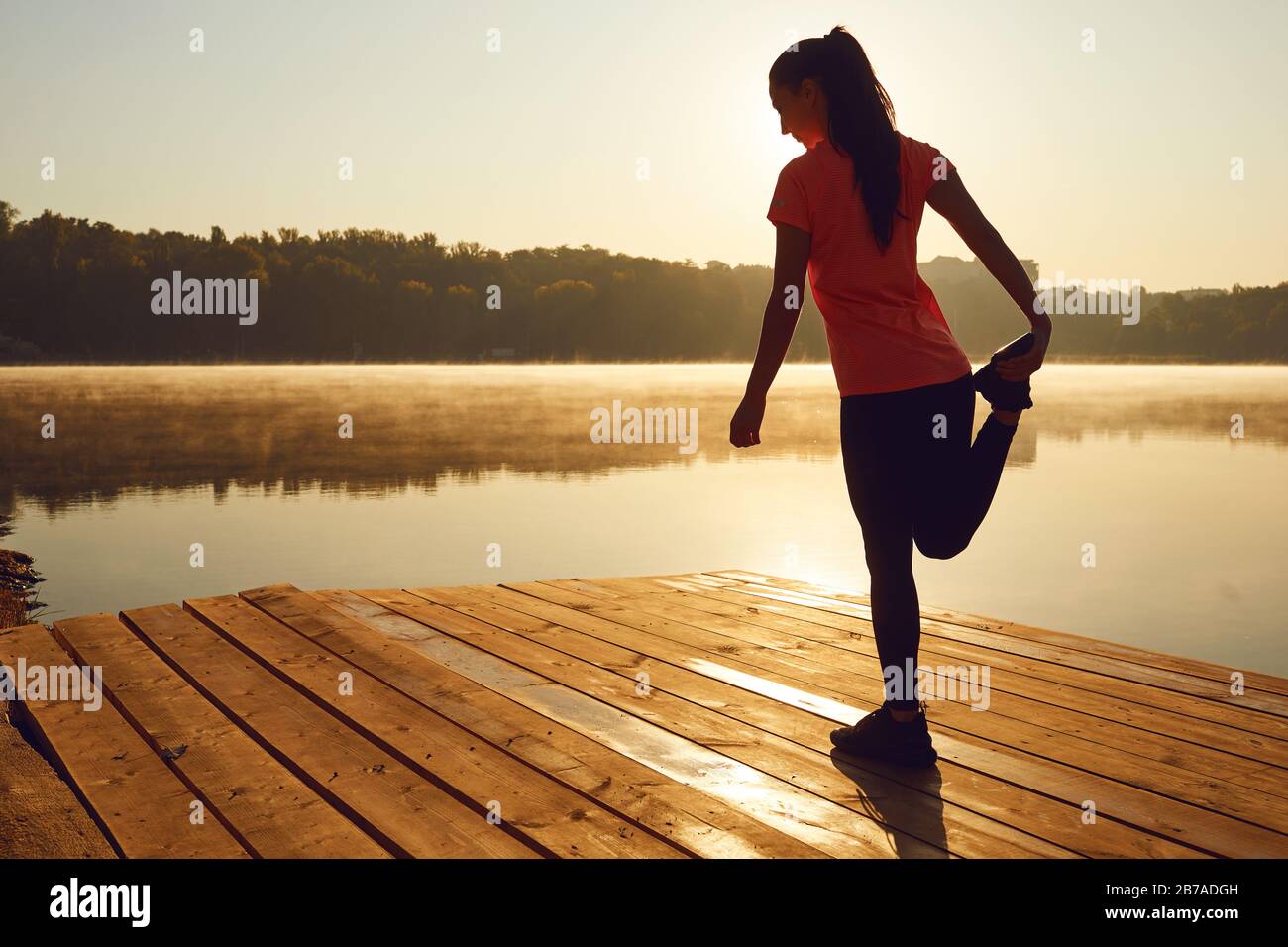 Warm up the legs stretching in the sport Stock Photo - Alamy