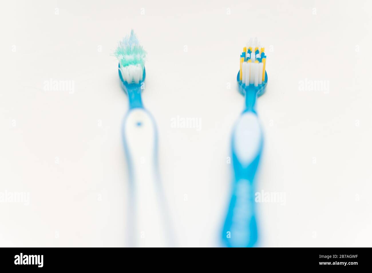 Old and new toothbrushes on a white background. Prevention of caries ...