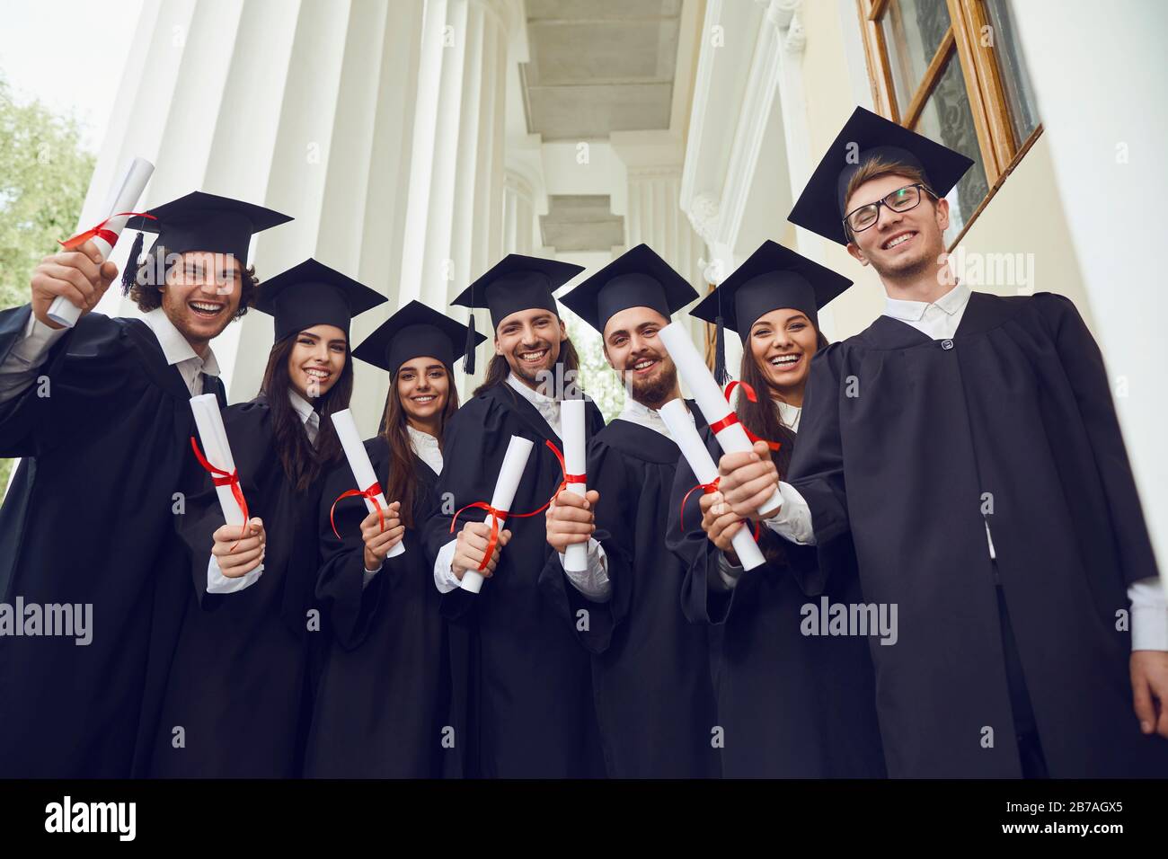 A group of graduates smiling Stock Photo - Alamy