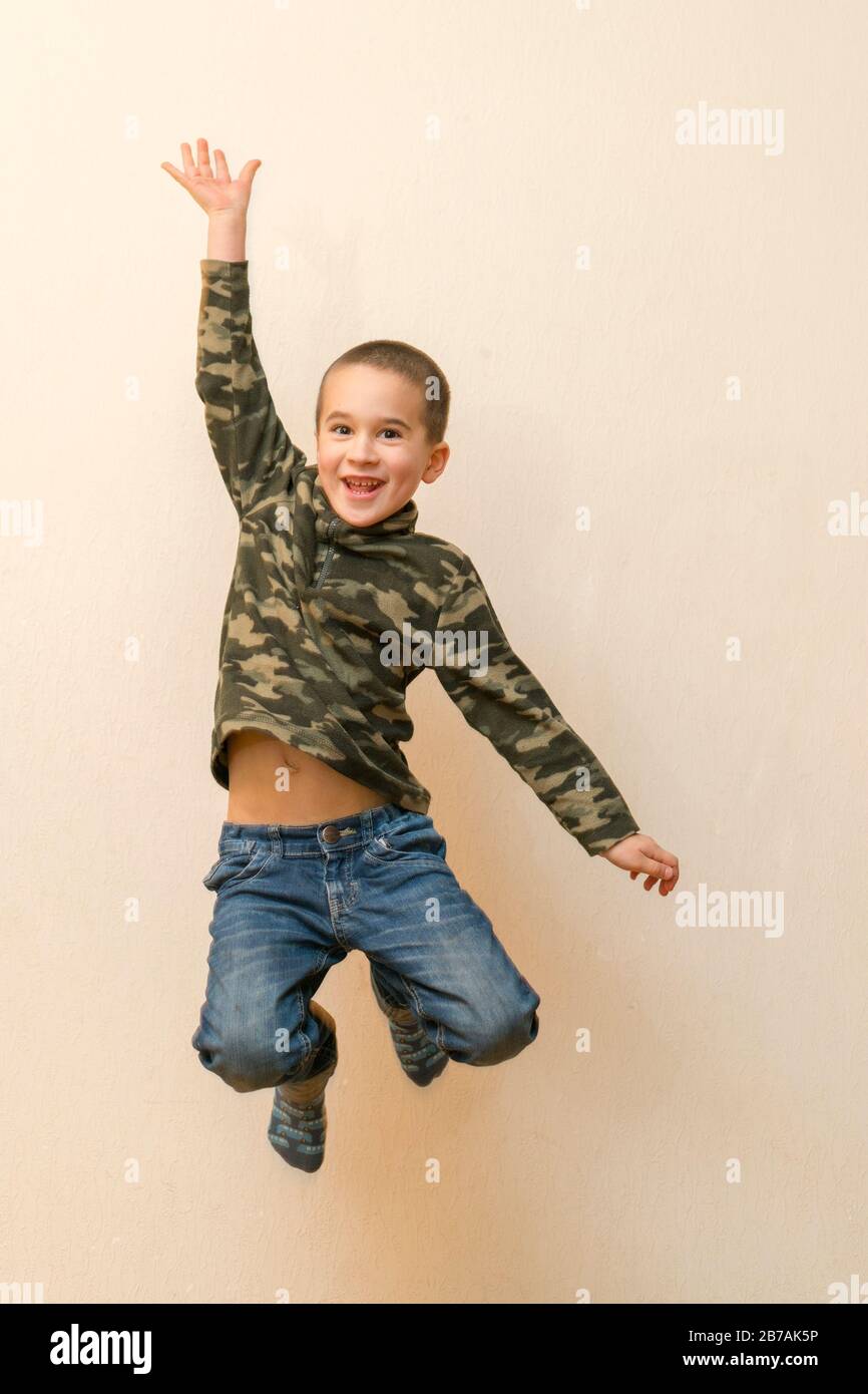 boy laying in the house. children playing at home. jumping children ...