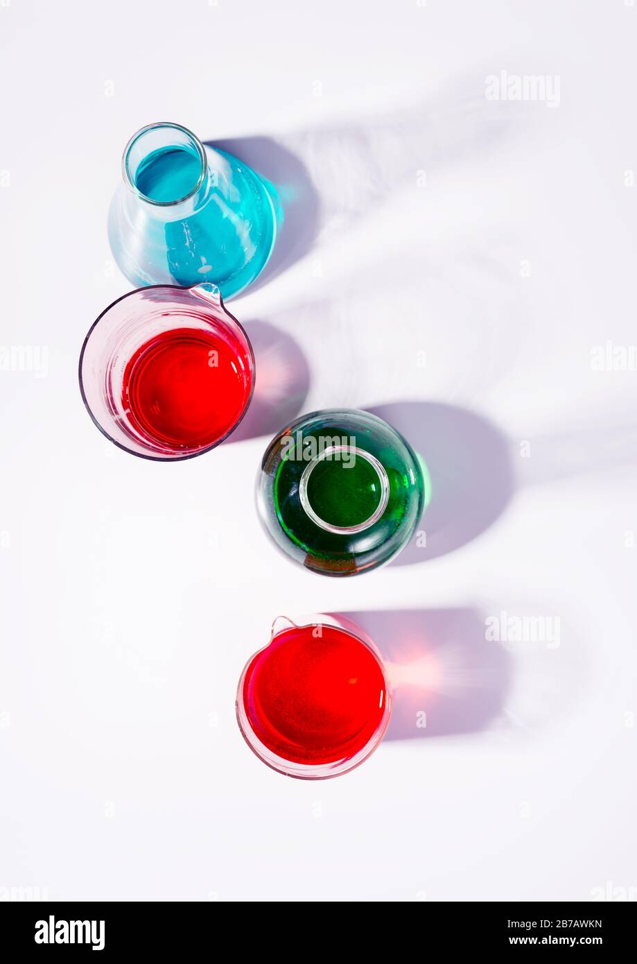 Science laboratory flasks full of a color liquid. Top view trendy still life Stock Photo - Alamy