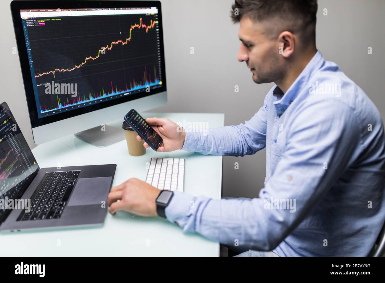Agent trader man talking at telephone and checking business stock data ...