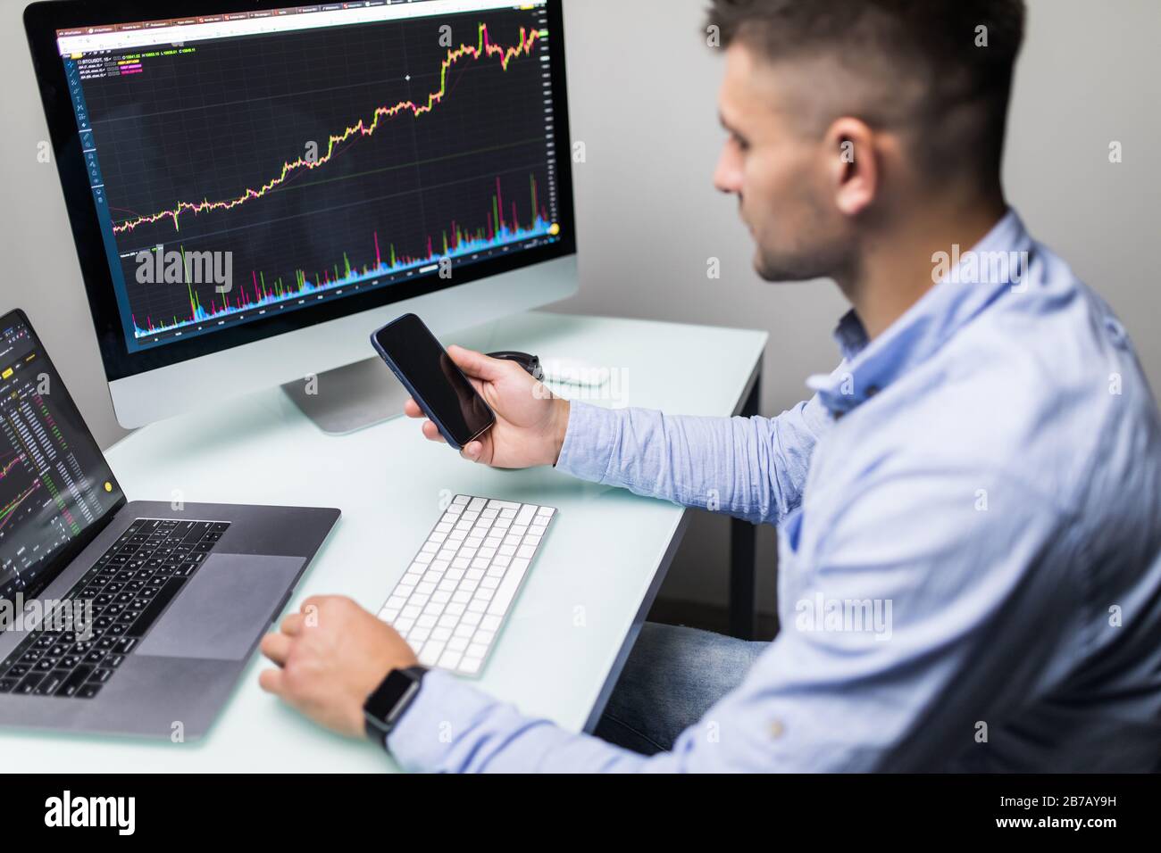 Agent trader man talking at telephone and checking business stock data ...