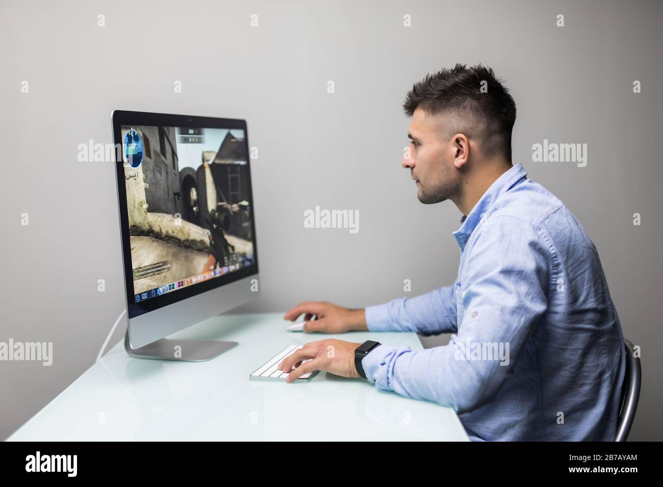 Shot of the Professional Gamer Playing in First-Person Shooter Online ...