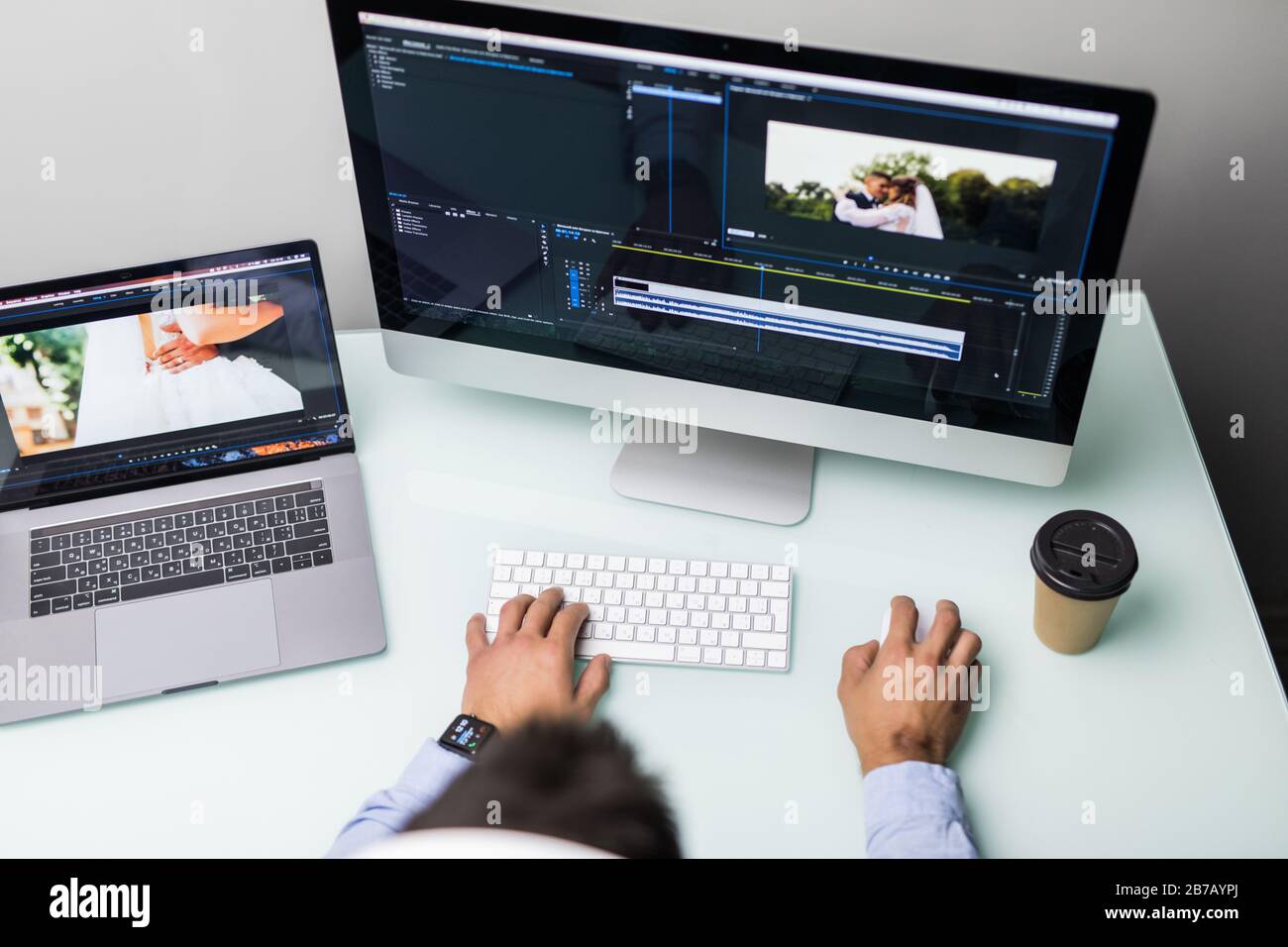 Low angle view of young man video editor with works with footage on his ...