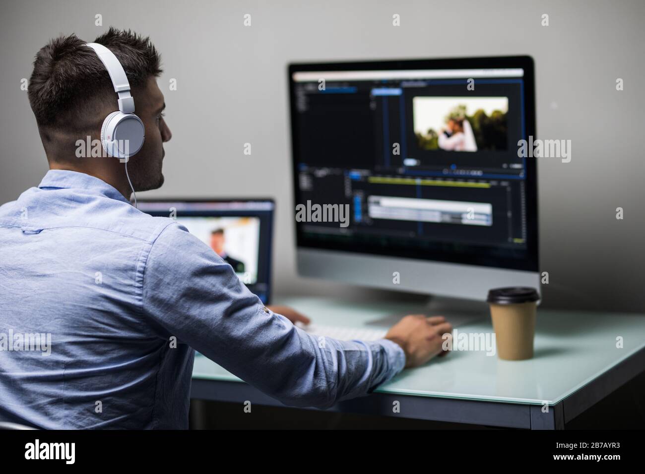 back view of video editor using computer Stock Photo - Alamy