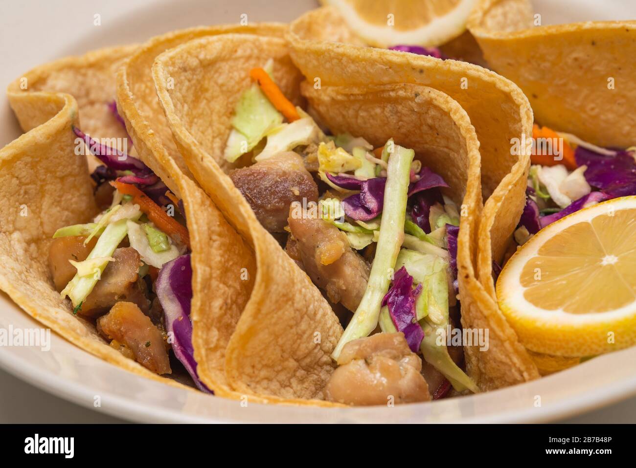 Spicy homemade chicken tocos close up on a plate Stock Photo - Alamy