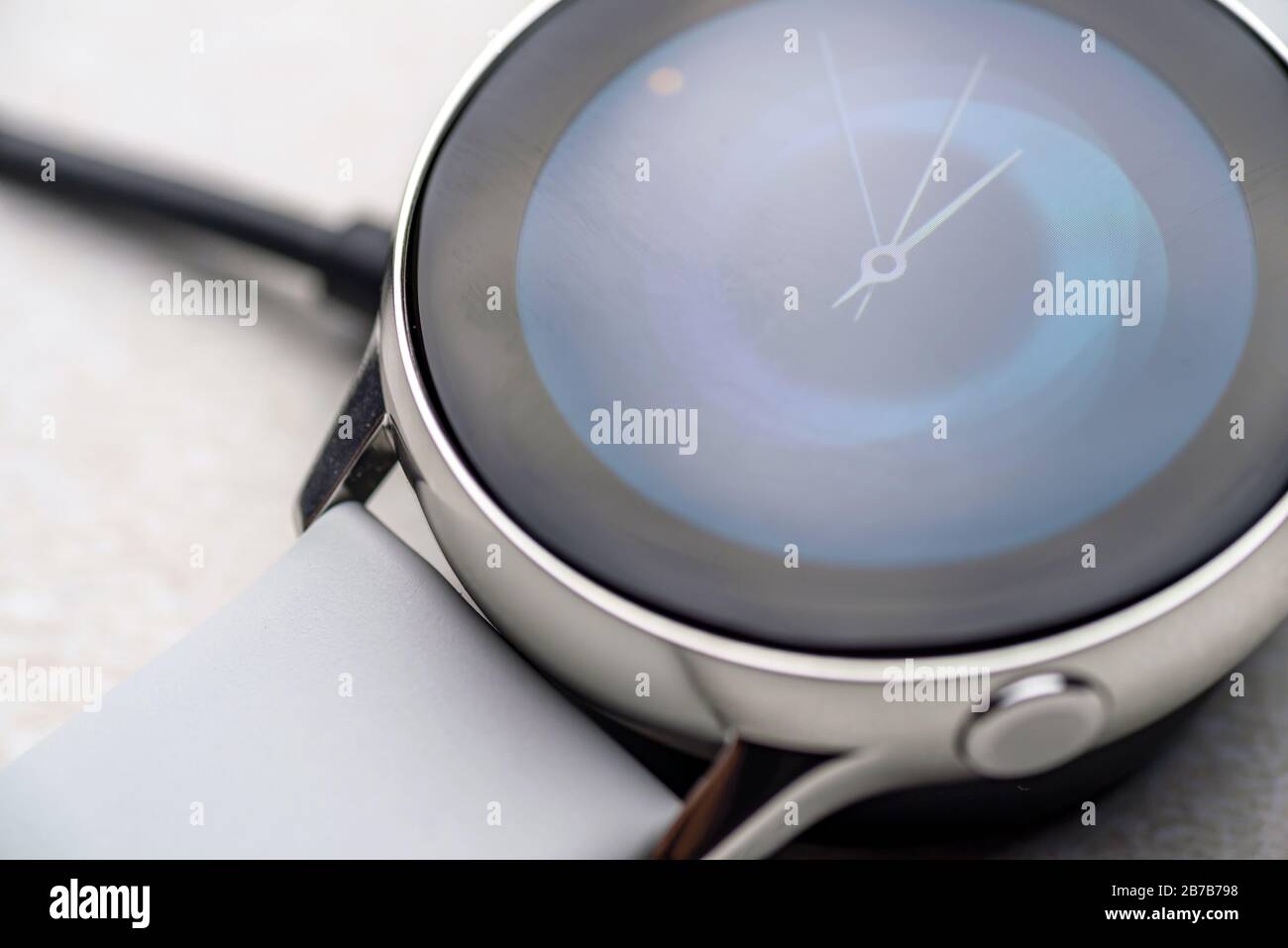 smart watch wireless charging on charging pad on kitchen worktop table ...