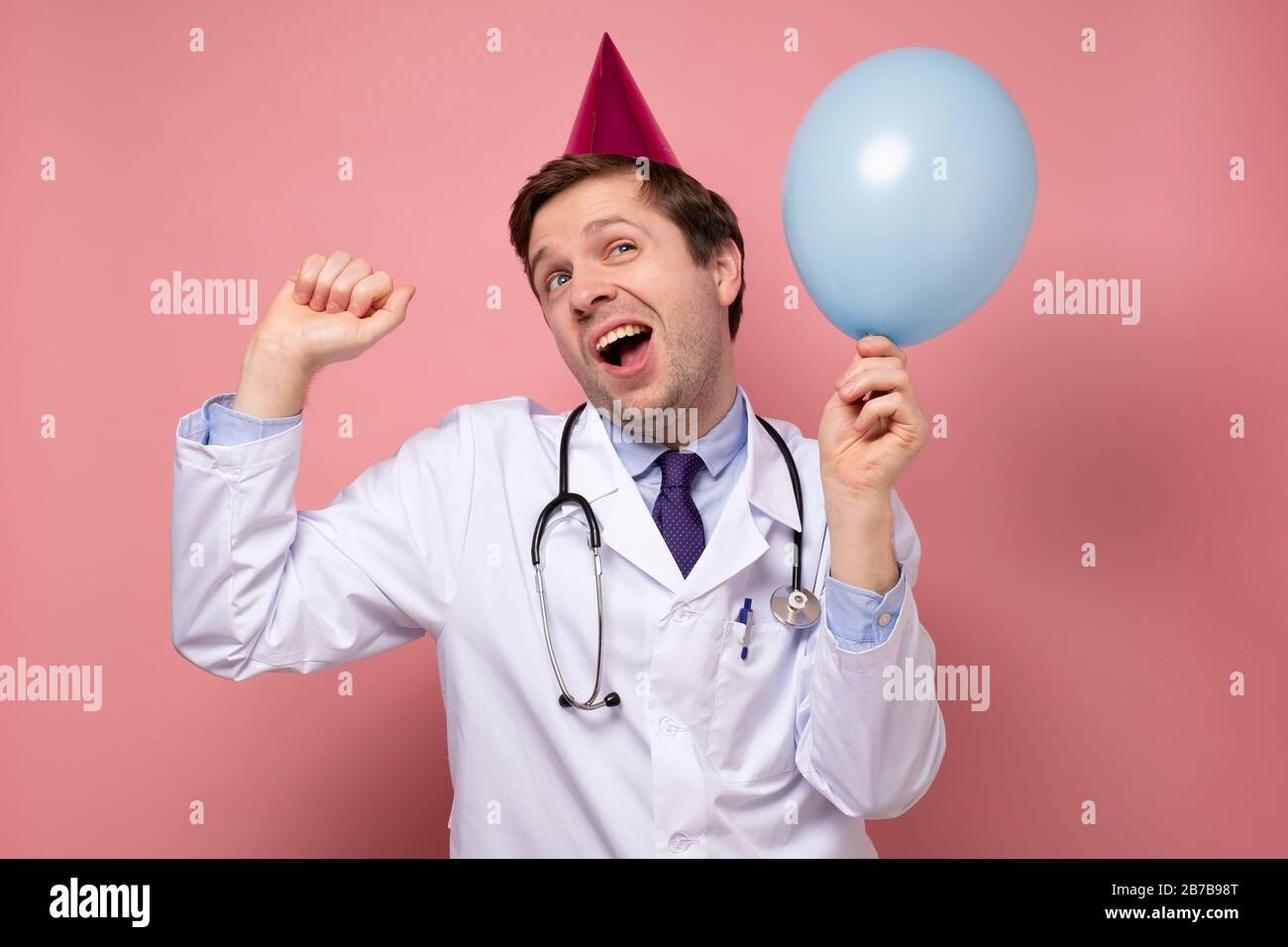 Young caucasian doctor in party holiday is glad with recovery of his ...