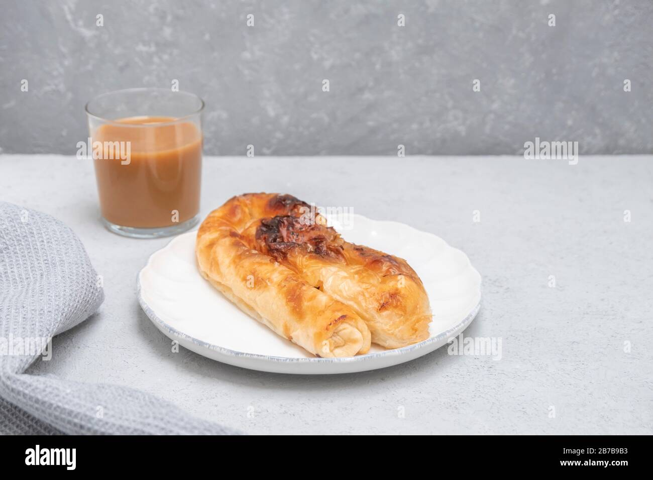 Traditional bulgarian homemade pie with cheese Banitsa with a glass of ...