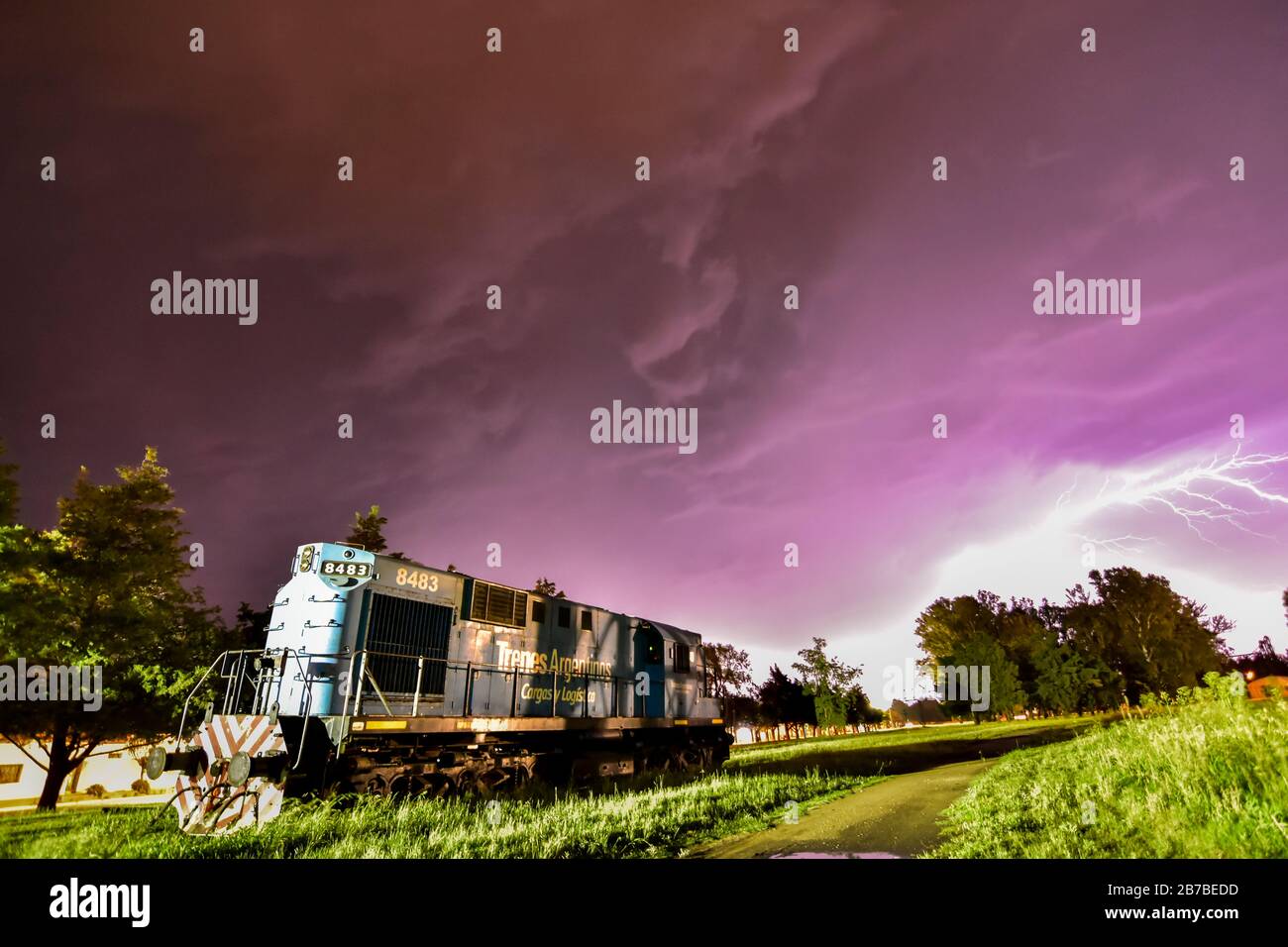 Scene view of a locomotive beneath a thunderstorm during summer night ...