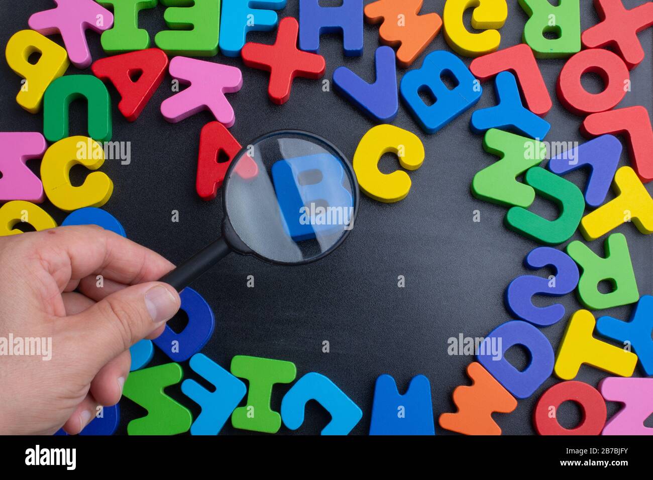 Magnifying glass and Colorful Letters of Alphabet Stock Photo - Alamy