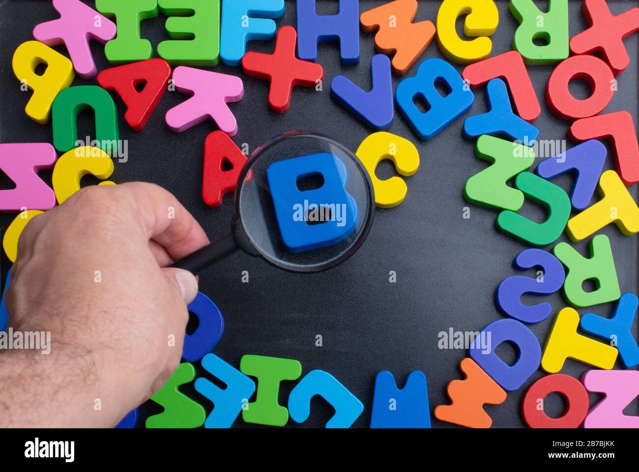 Magnifying glass and Colorful Letters of Alphabet Stock Photo - Alamy