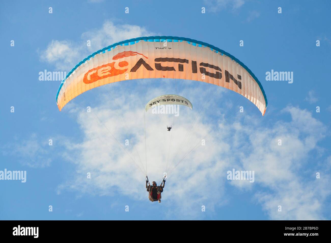 Two solo paragliders with white and blue parachute at Calis in Turkey ...