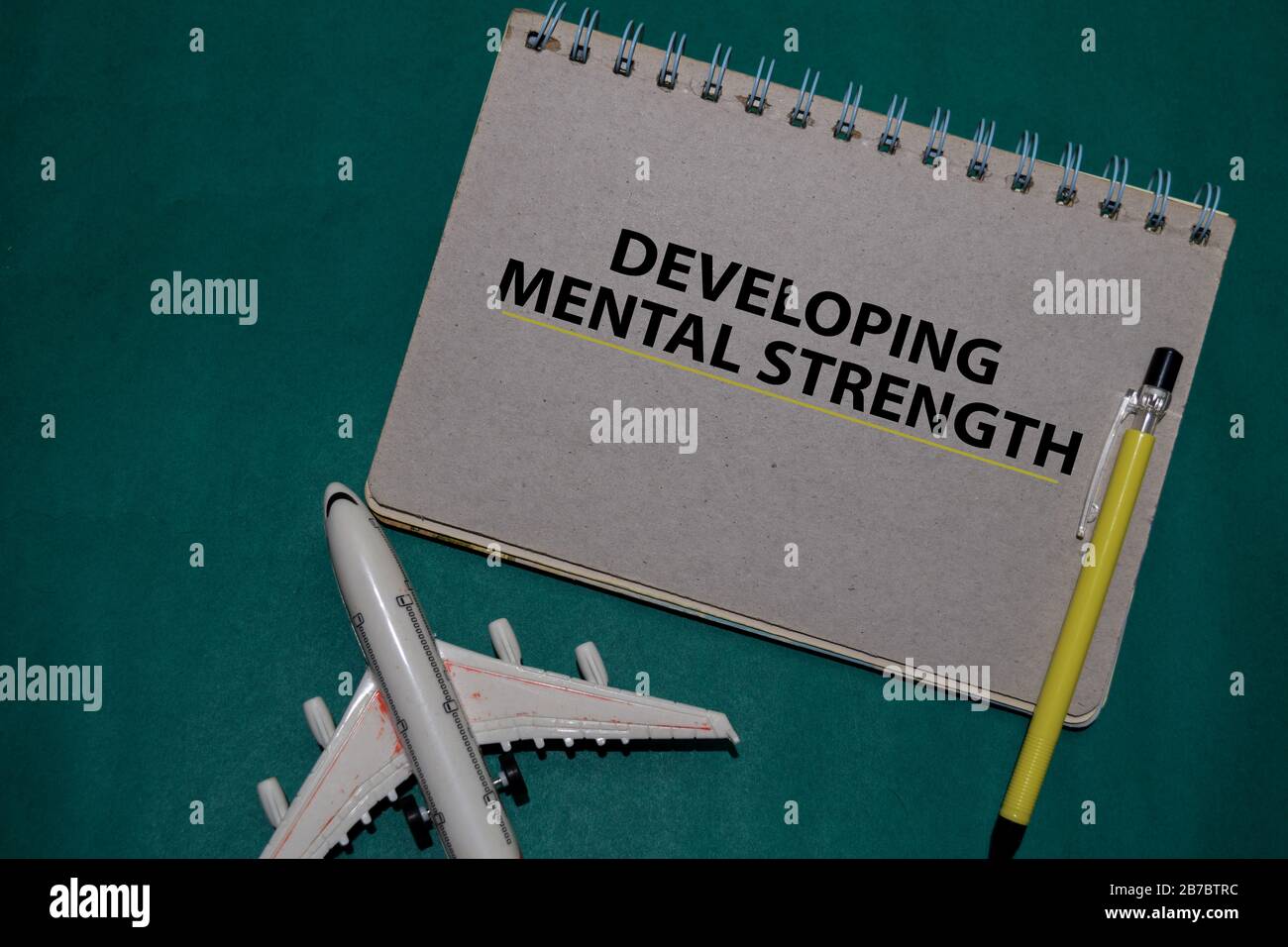 Developing Mental Strength write on a book isolated on Office Desk ...