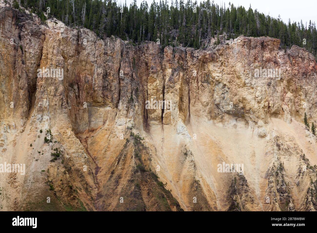 Steep rock walls that have been eroded over time and topped with ...