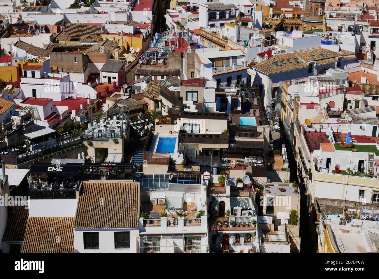 Colorful and busy aerial view of Seville, Spain, showing swimming pools ...
