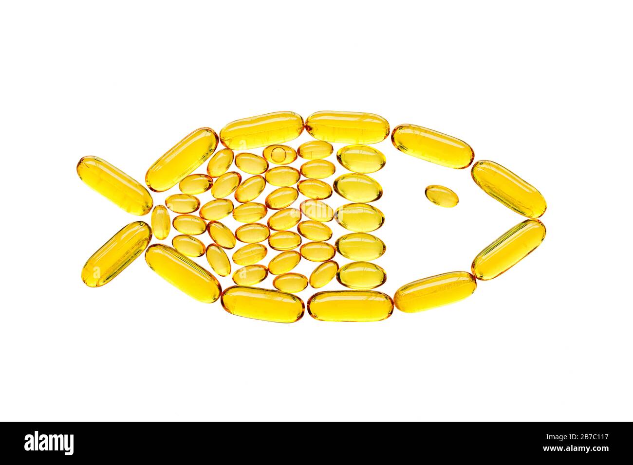 Transparent yellow medical capsules in fish shape, isolated on white ...
