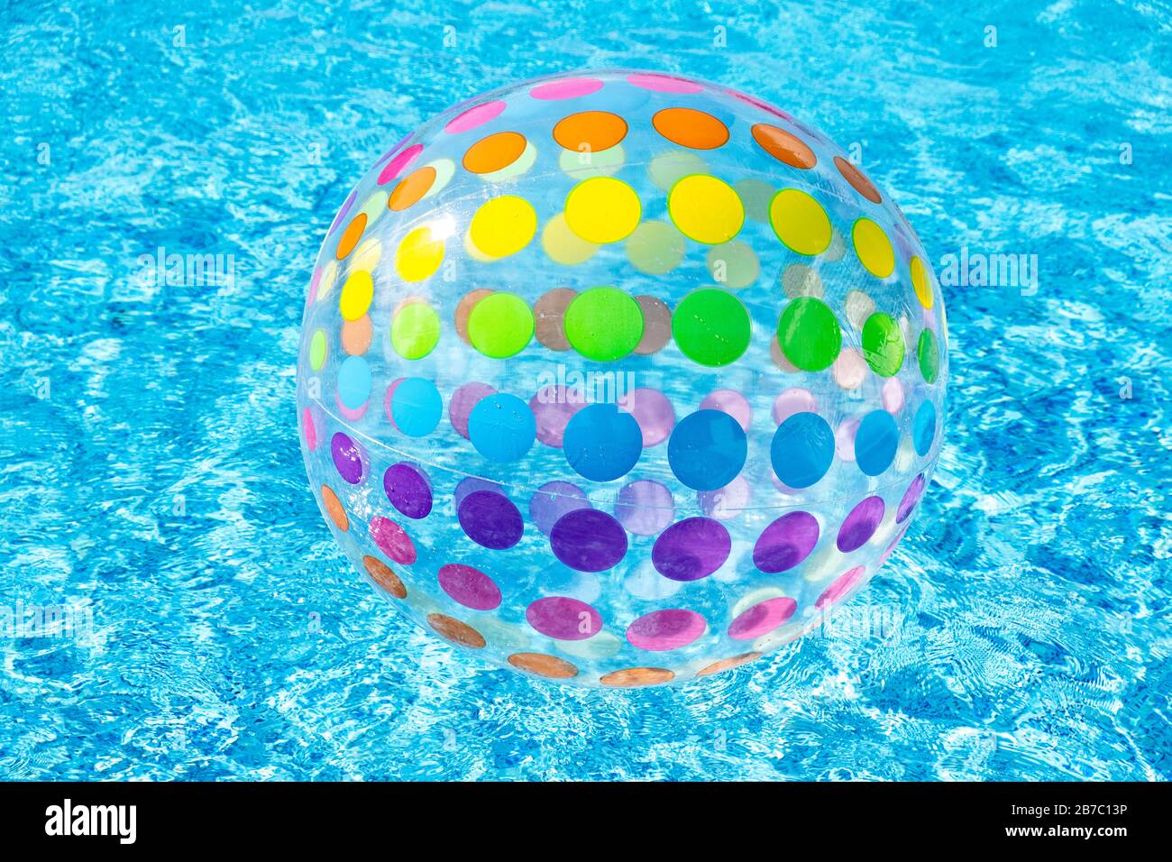 Inflatable colorful dotty Beach Ball Floating On Surface Of Swimming ...