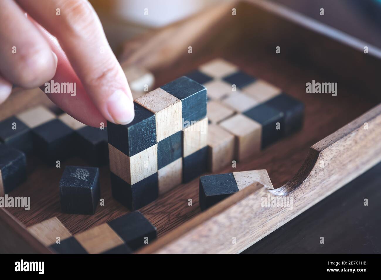 Closeup image of people playing and building wooden puzzle game Stock ...