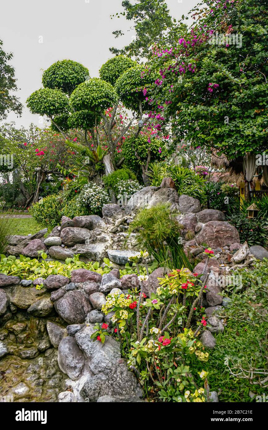 Beautiful garden with green lawn and colorful flowers Stock Photo - Alamy