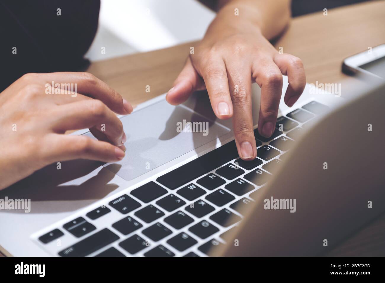 Closeup image of hands working and typing on laptop keyboard with blur ...