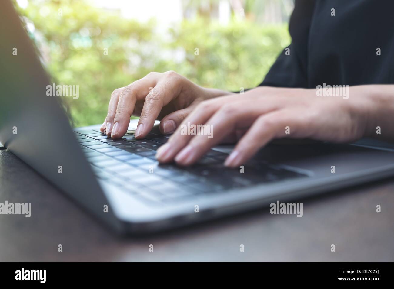 Closeup image of hands working and typing on laptop keyboard in office ...