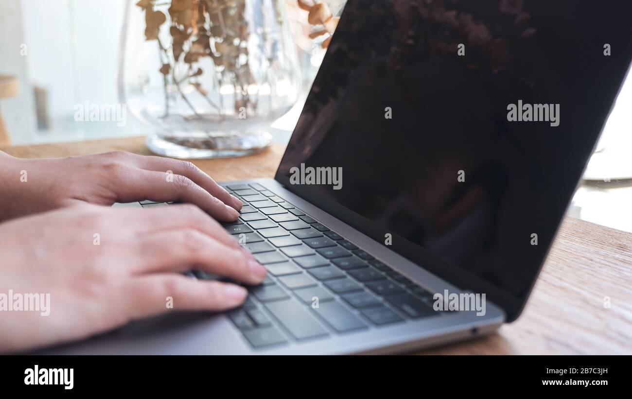 Closeup image of hands working and typing on laptop keyboard in office ...