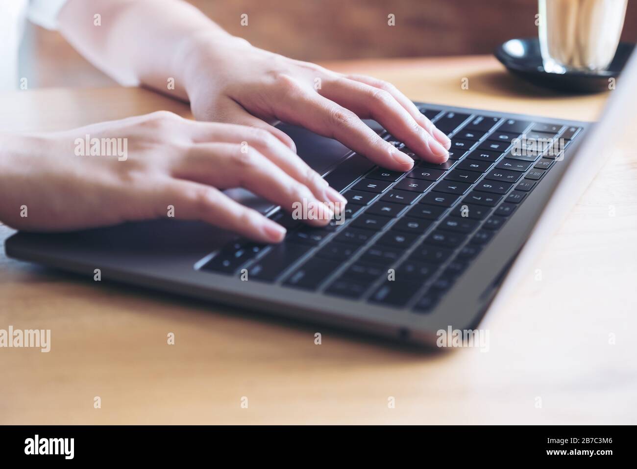 Closeup image of hands working and typing on laptop keyboard in office ...