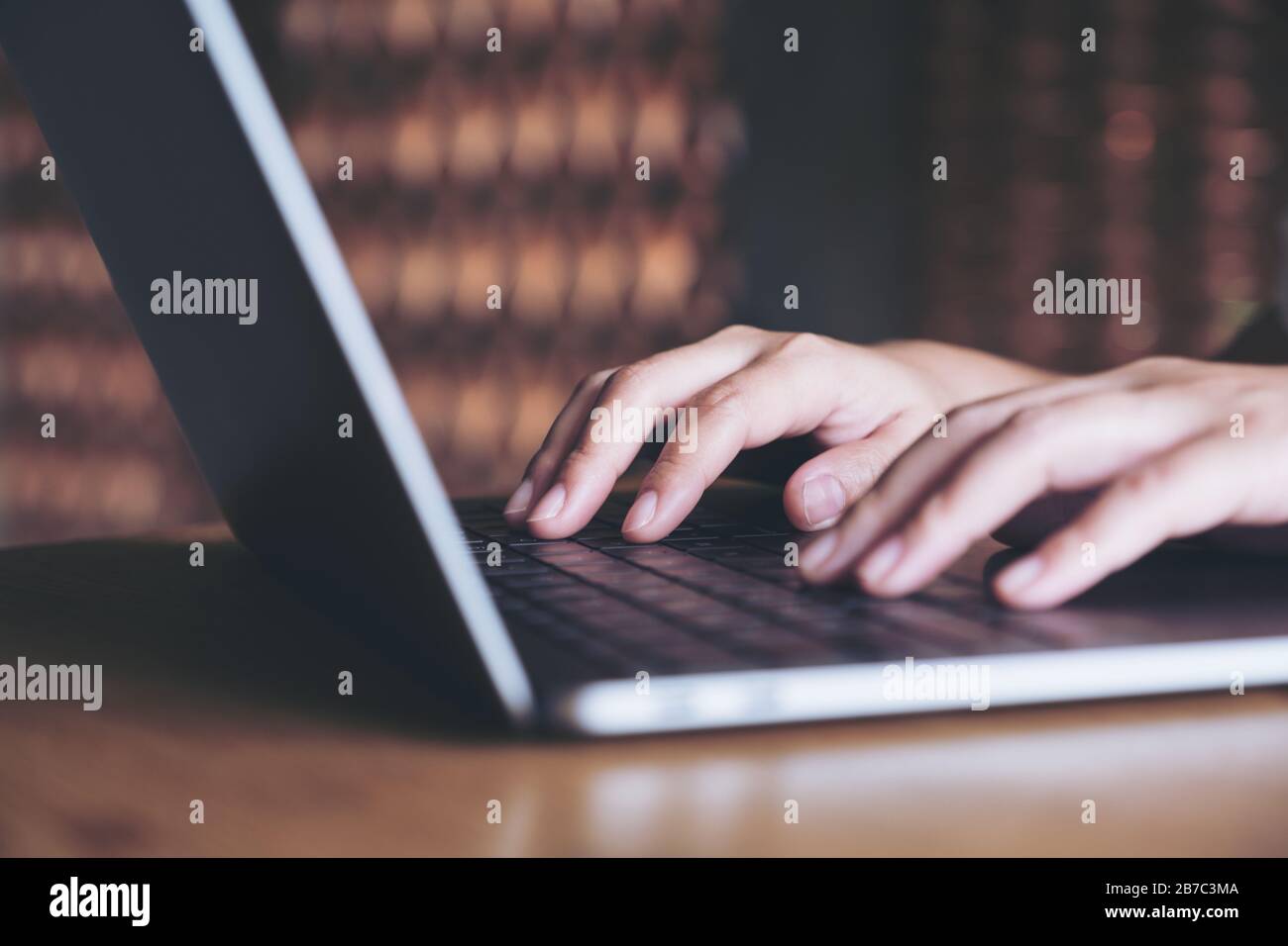 Closeup image of hands working and typing on laptop keyboard in office ...