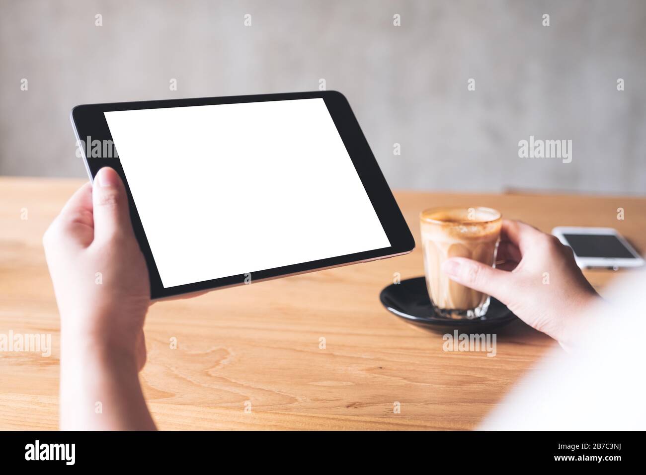 Mockup image of a woman holding black tablet pc with blank white ...