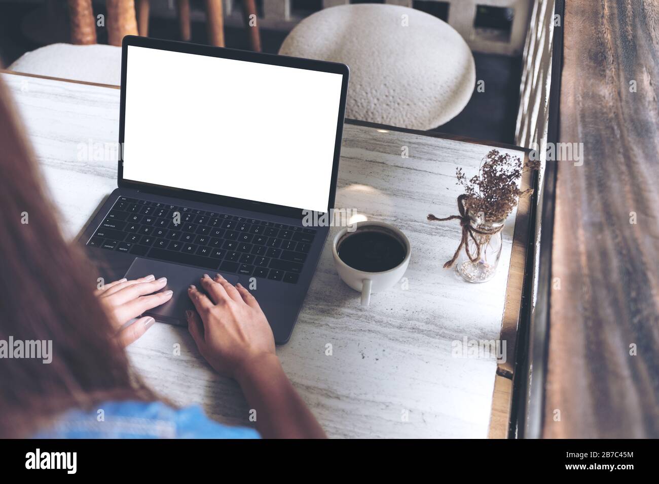 Mockup image of a woman using and typing on laptop with blank white ...