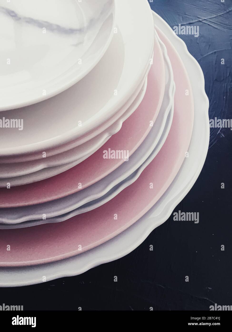 Stack of clean empty plates on black background, luxe dishware and ...