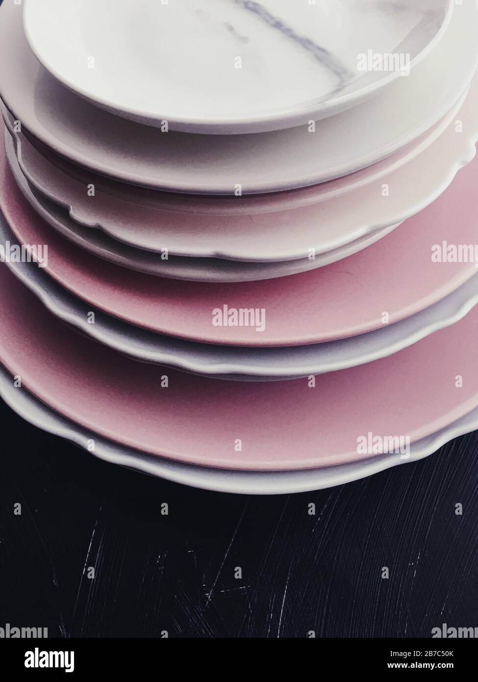 Stack of clean empty plates on black background, luxe dishware and ...