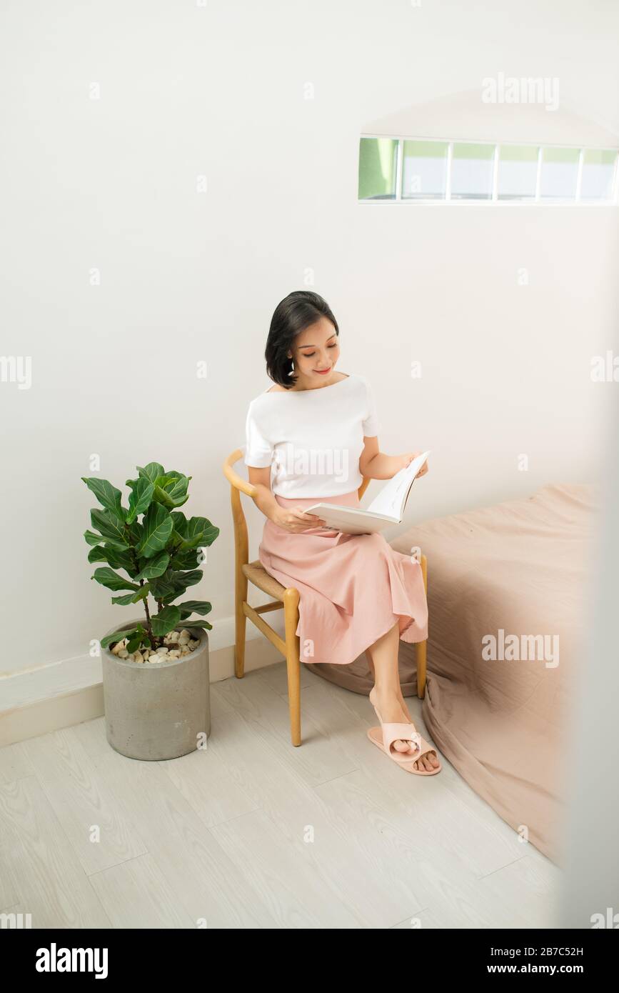 Young woman chilling at home in chair Stock Photo - Alamy