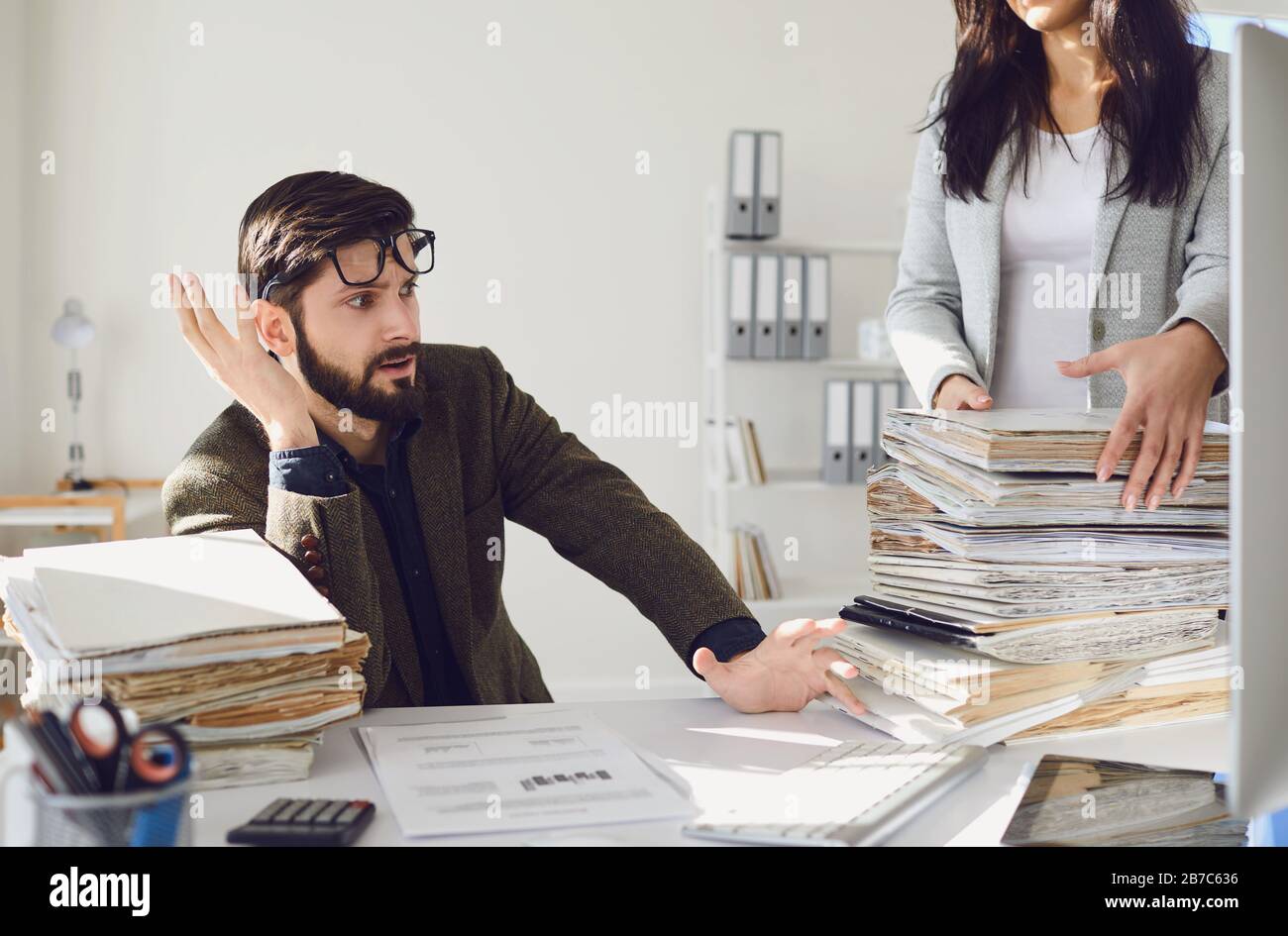 Worker businessman tired upset indignant unhappy sitting at workplace ...