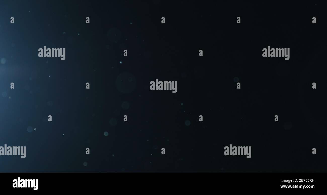 natural dust particles float in air on black background, wide photo ...