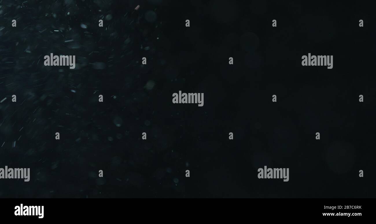 natural dust particles flow in air on black background, wide photo ...