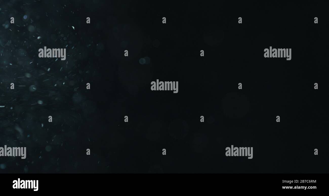 natural dust particles flow in air on black background, wide photo ...